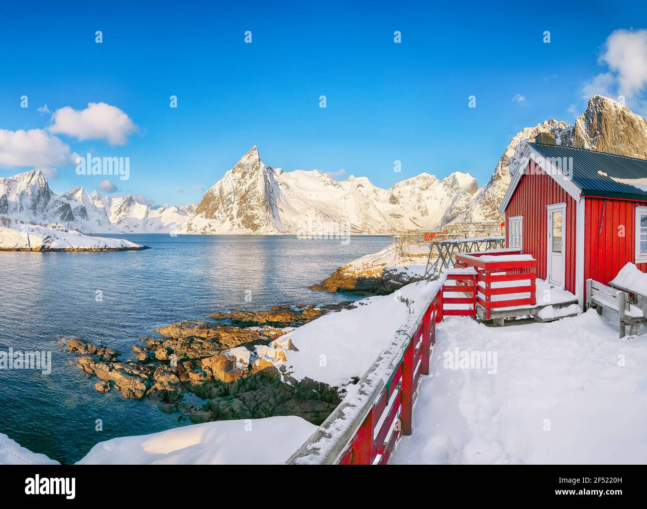 Traditional Norwegian red wooden houses on the shore of Reinefjorden in ...