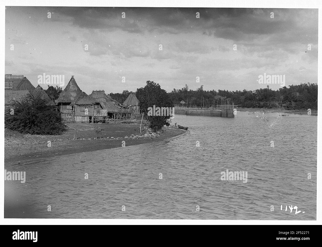 At Manila (Philippines). Fishing village with traditional Nipa huts on ...