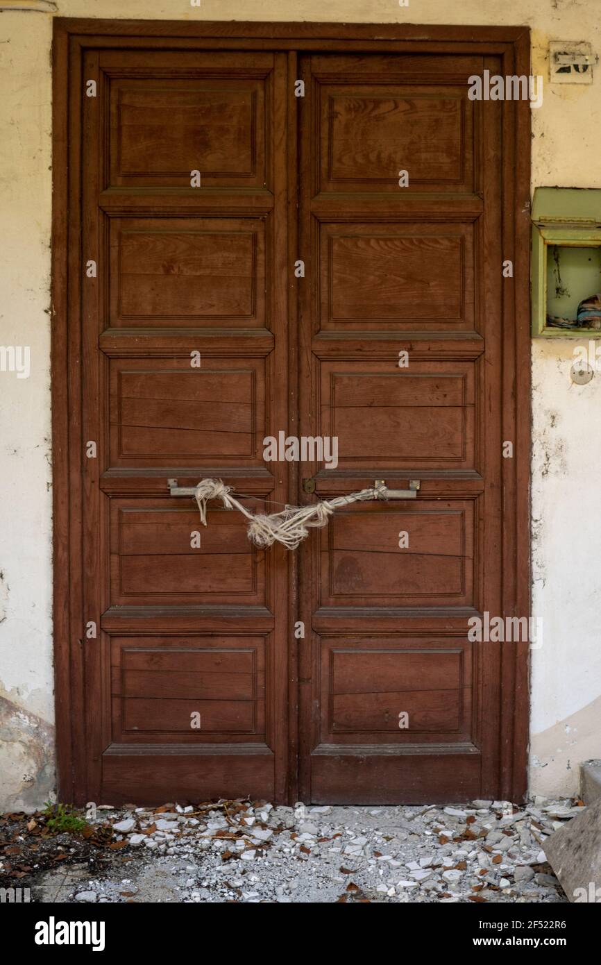 Closed locked door of an old abandoned building Stock Photo - Alamy
