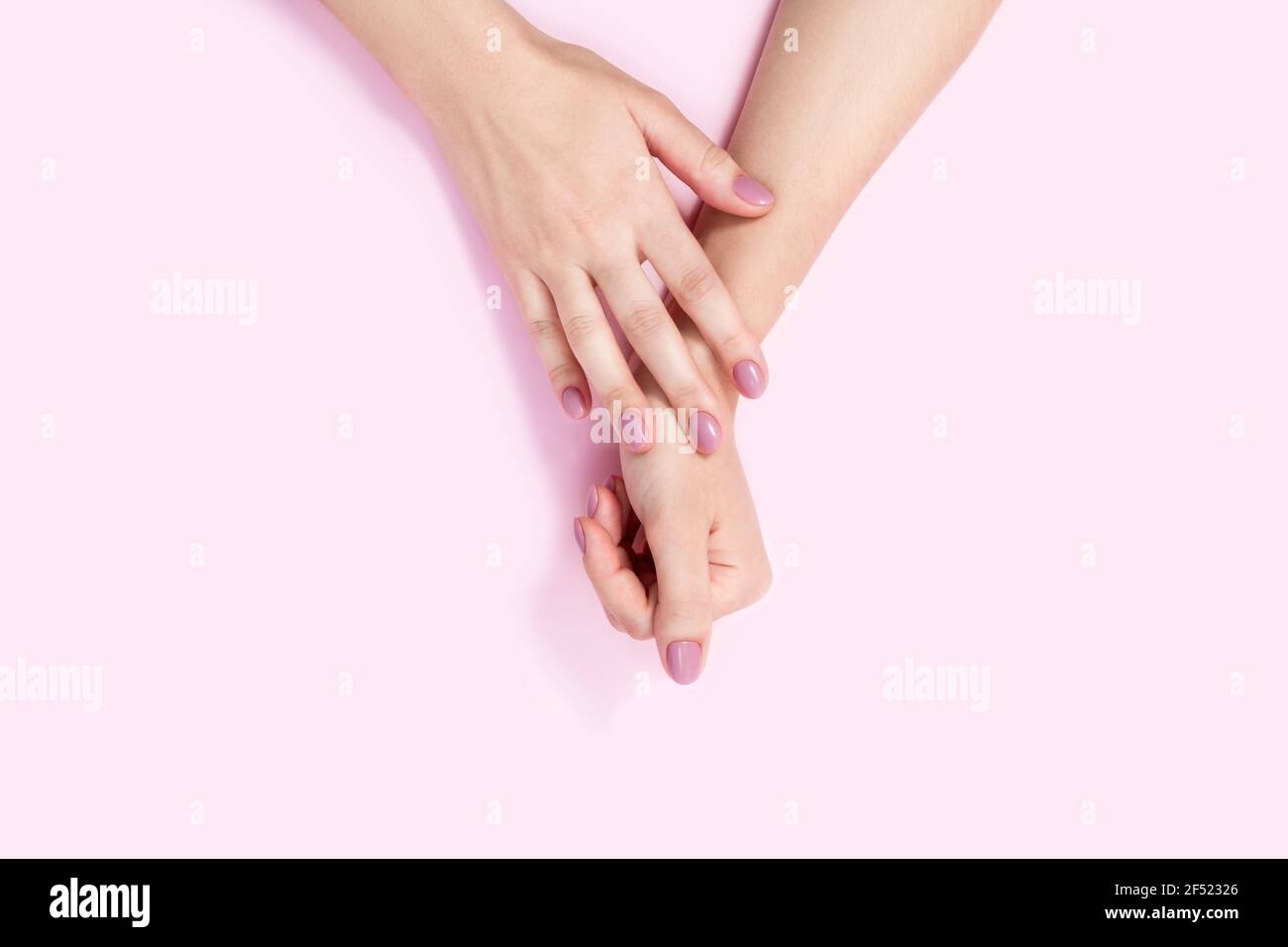 Beautiful female hands on a pink background Stock Photo - Alamy