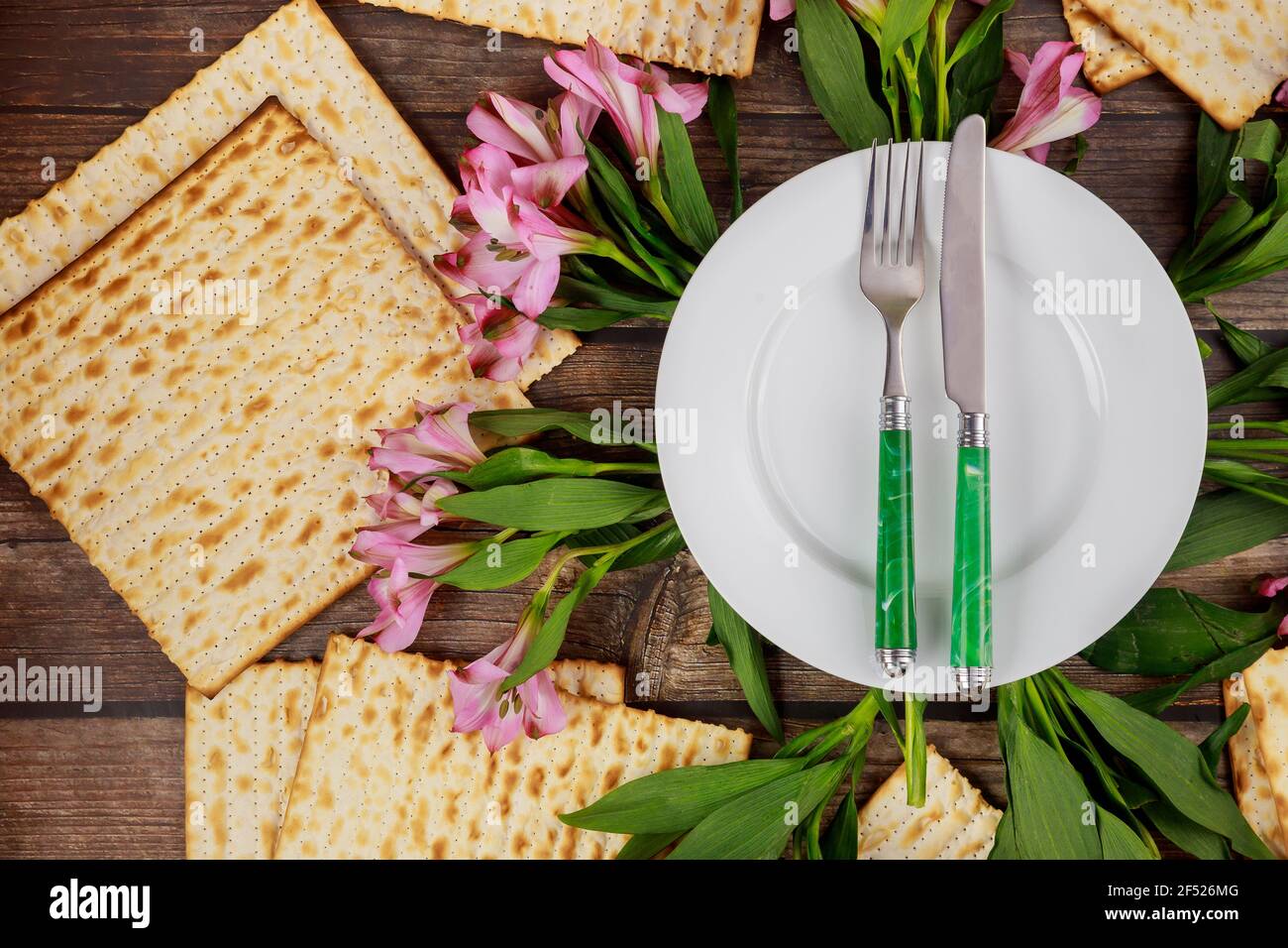 Dinner table setting with flowers for Passover. Jewish holiday Pesach ...