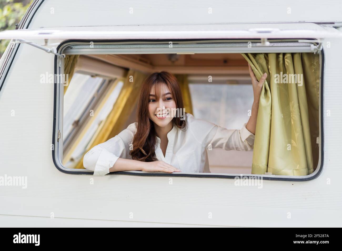 happy young woman at window of a camper RV van motorhome Stock Photo ...