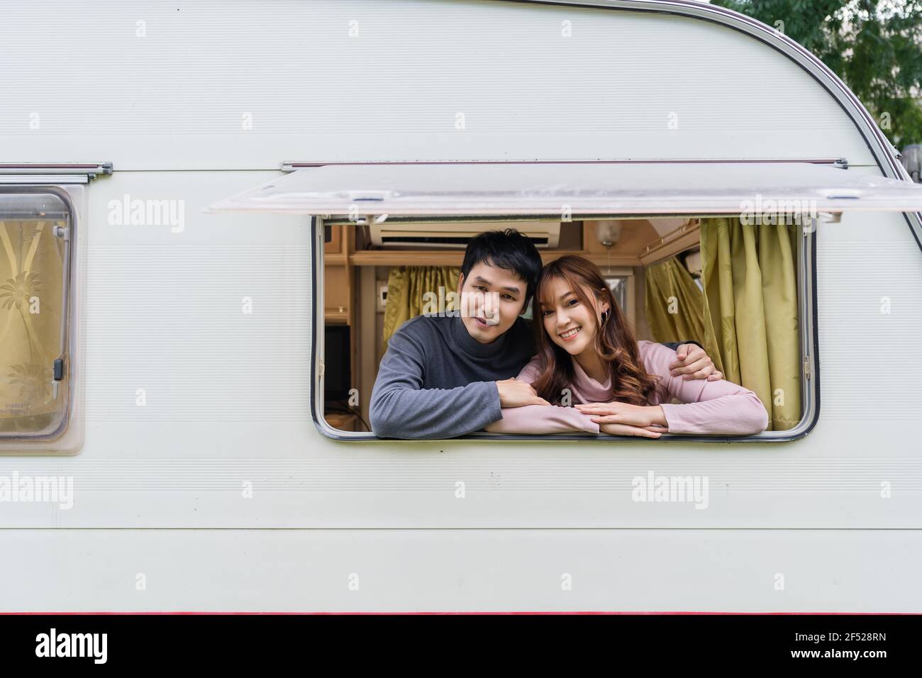 happy young couple at window of a camper RV van motorhome Stock Photo ...