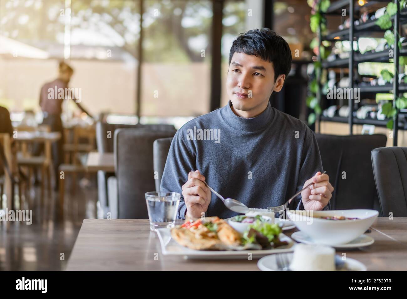 Asian eating breakfast at hotel hi-res stock photography and images - Alamy