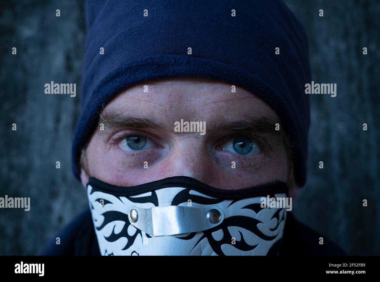 blue eyes boy wearing mask, serious look Stock Photo - Alamy
