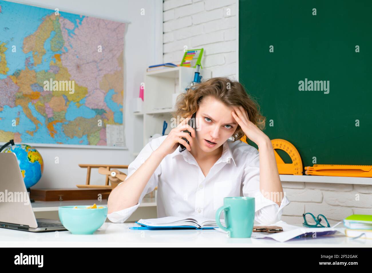 School angry teacher talking on smartphone. Education concept. Tutor in ...