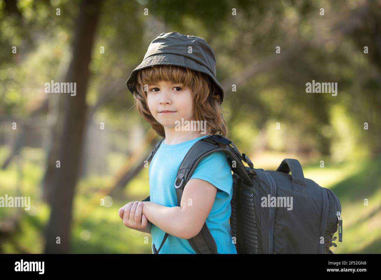 little boy with backpack hiking in scenic mountains. Boy local tourist ...
