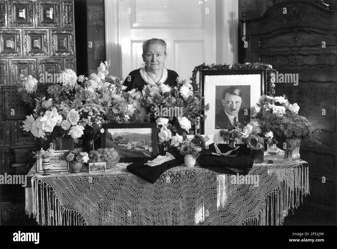 Old lady behind her birthday table with picture of the Obersalzberg and ...