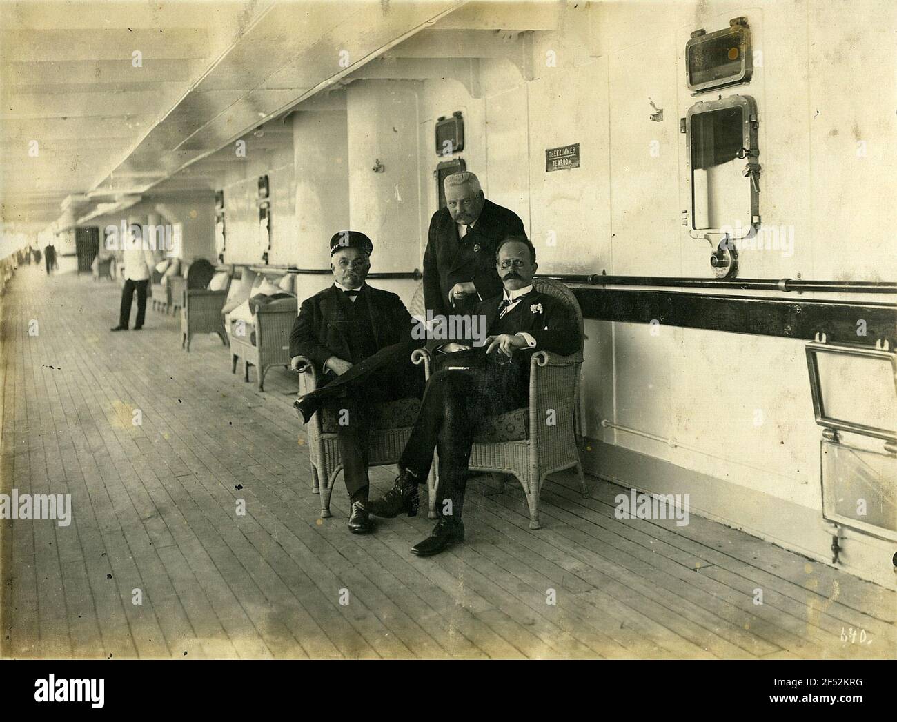 Group formation with three gentlemen on the promenade deck of a high ...