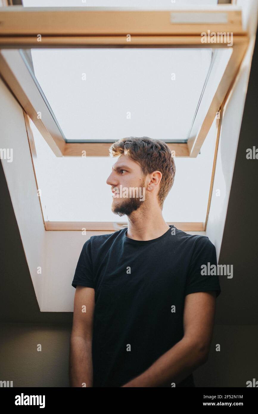 Bosnian Caucasian man standing under the attic window Stock Photo - Alamy