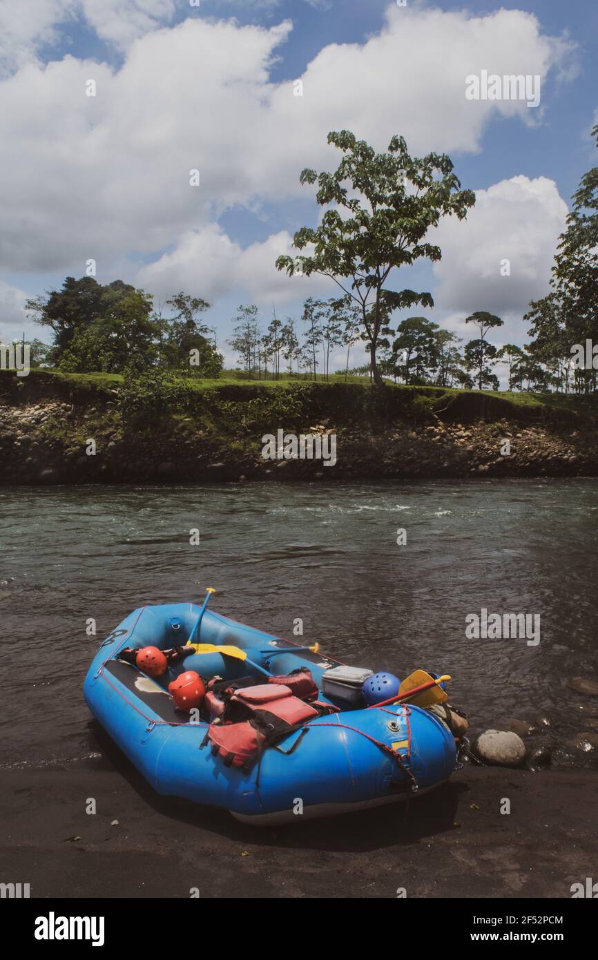 Blue empty raft on the bank of Sarapiqui River, Costa Rica Stock Photo ...