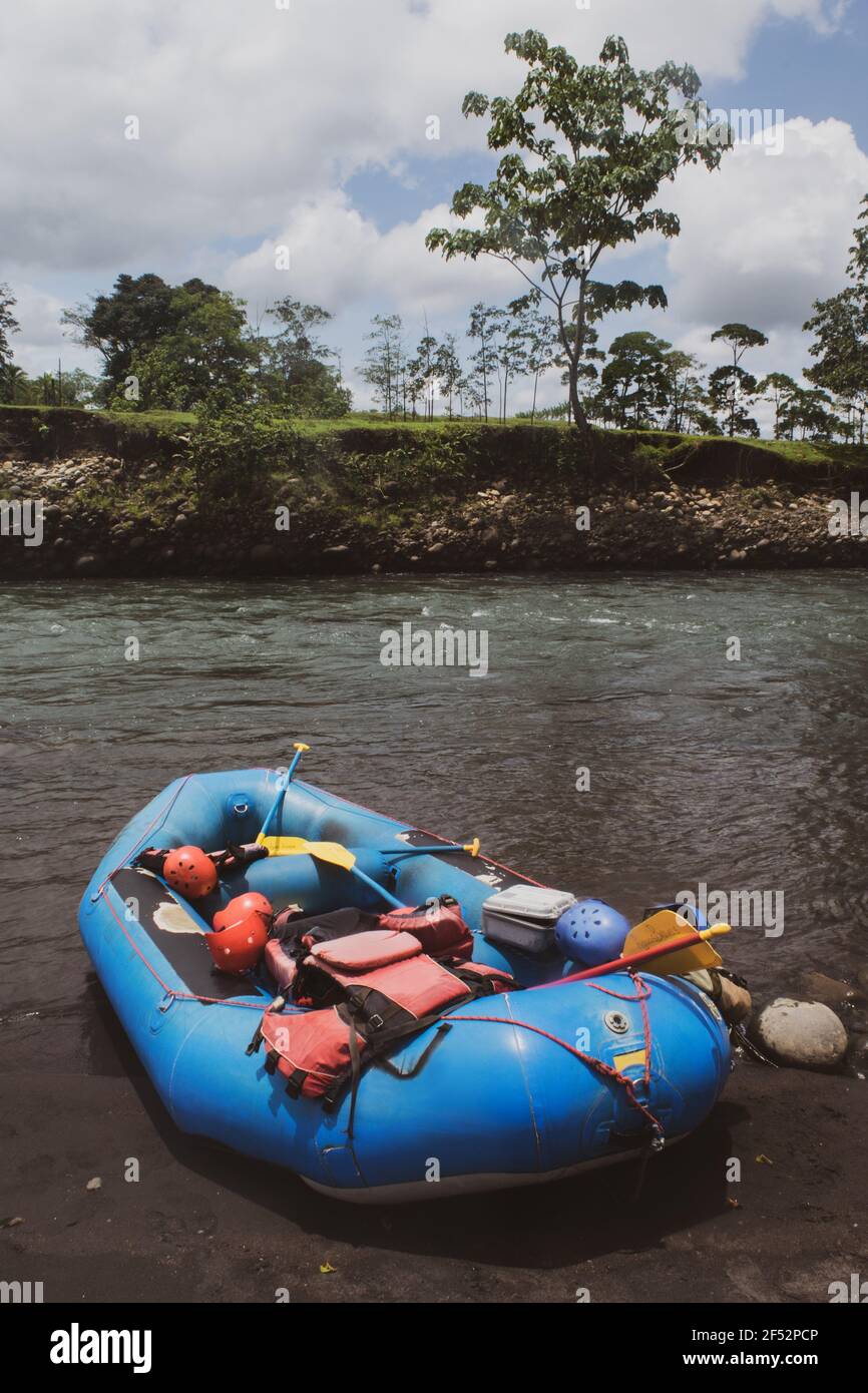 Blue empty raft on the bank of Sarapiqui River, Costa Rica Stock Photo ...