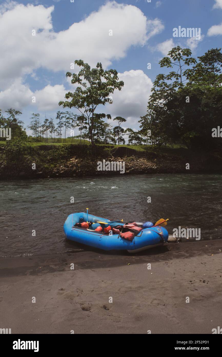 Blue empty raft on the bank of Sarapiqui River, Costa Rica Stock Photo ...
