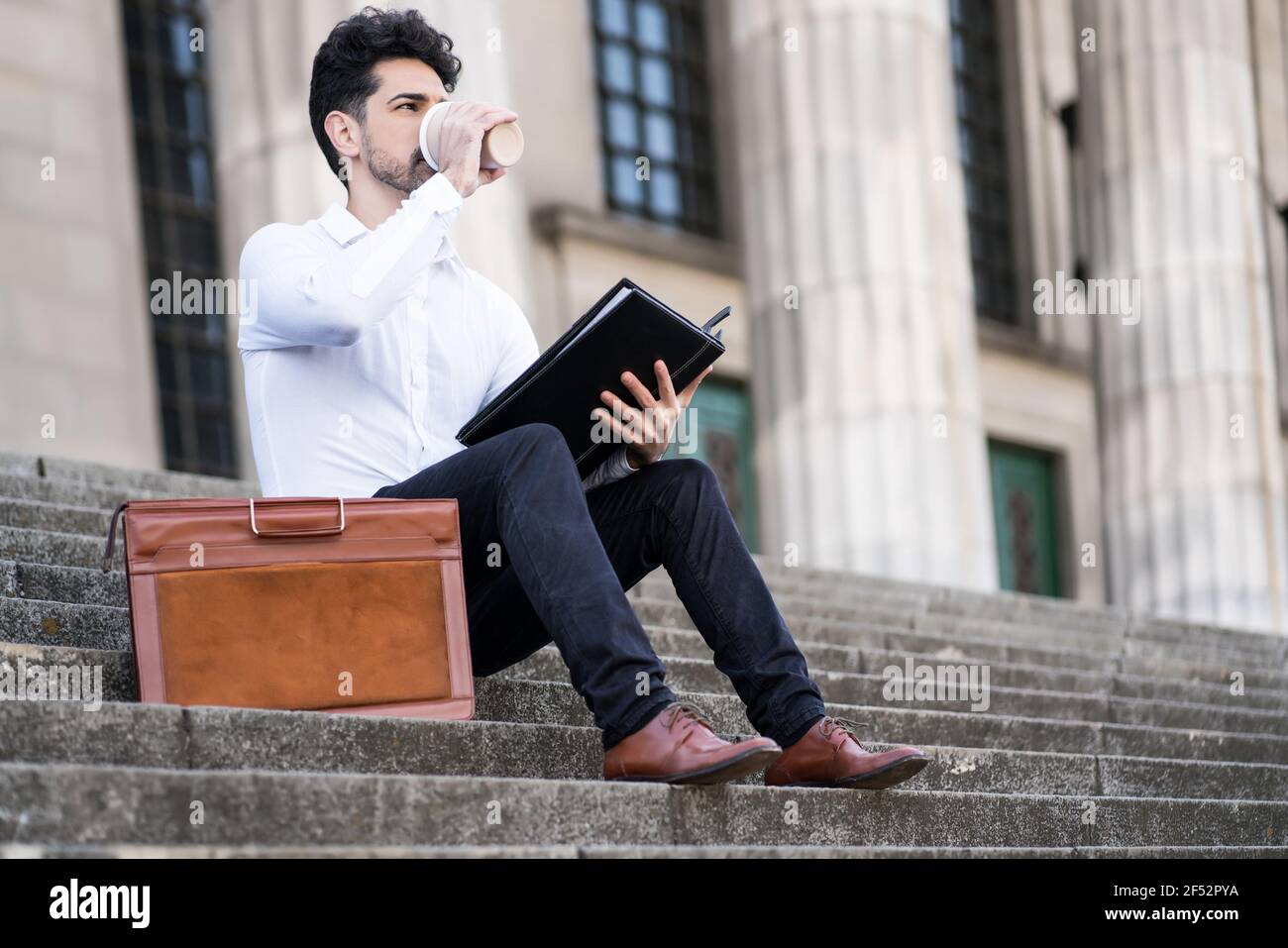Confident businessman reading documents hi-res stock photography and ...