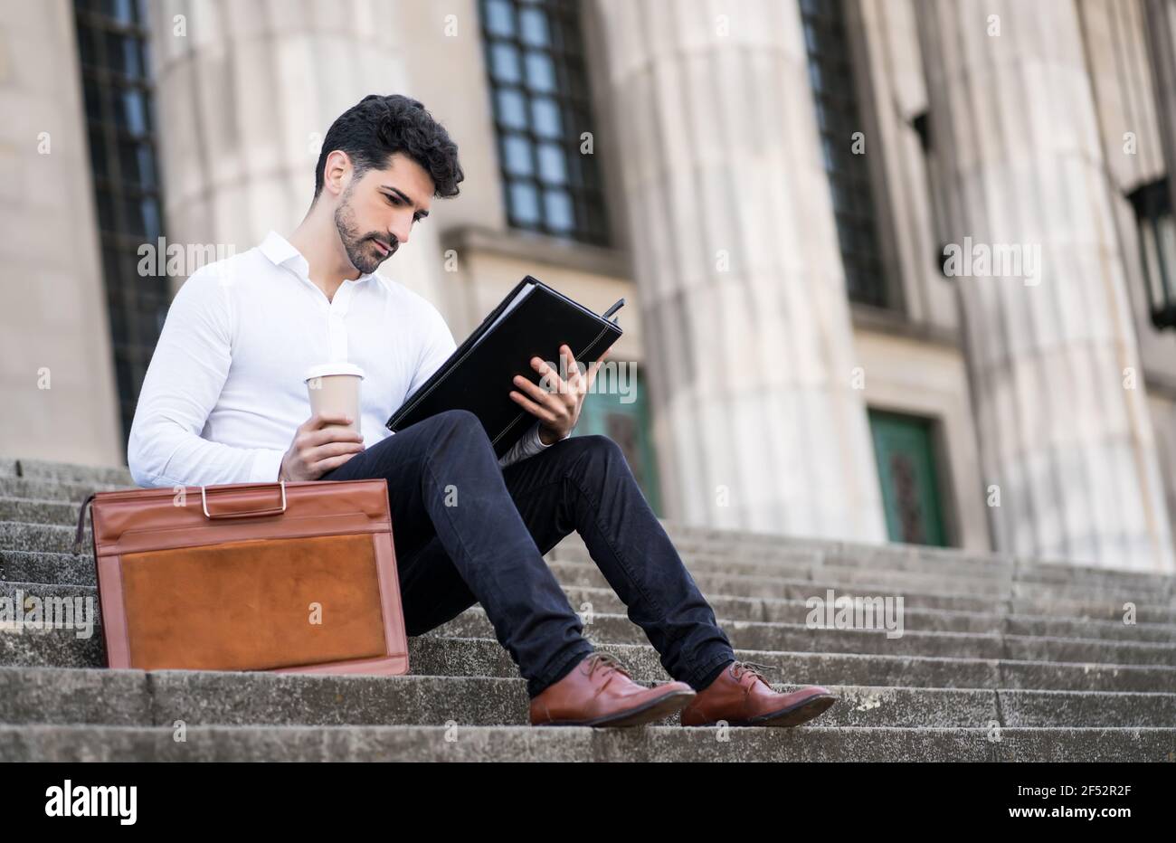 Confident businessman reading documents hi-res stock photography and ...