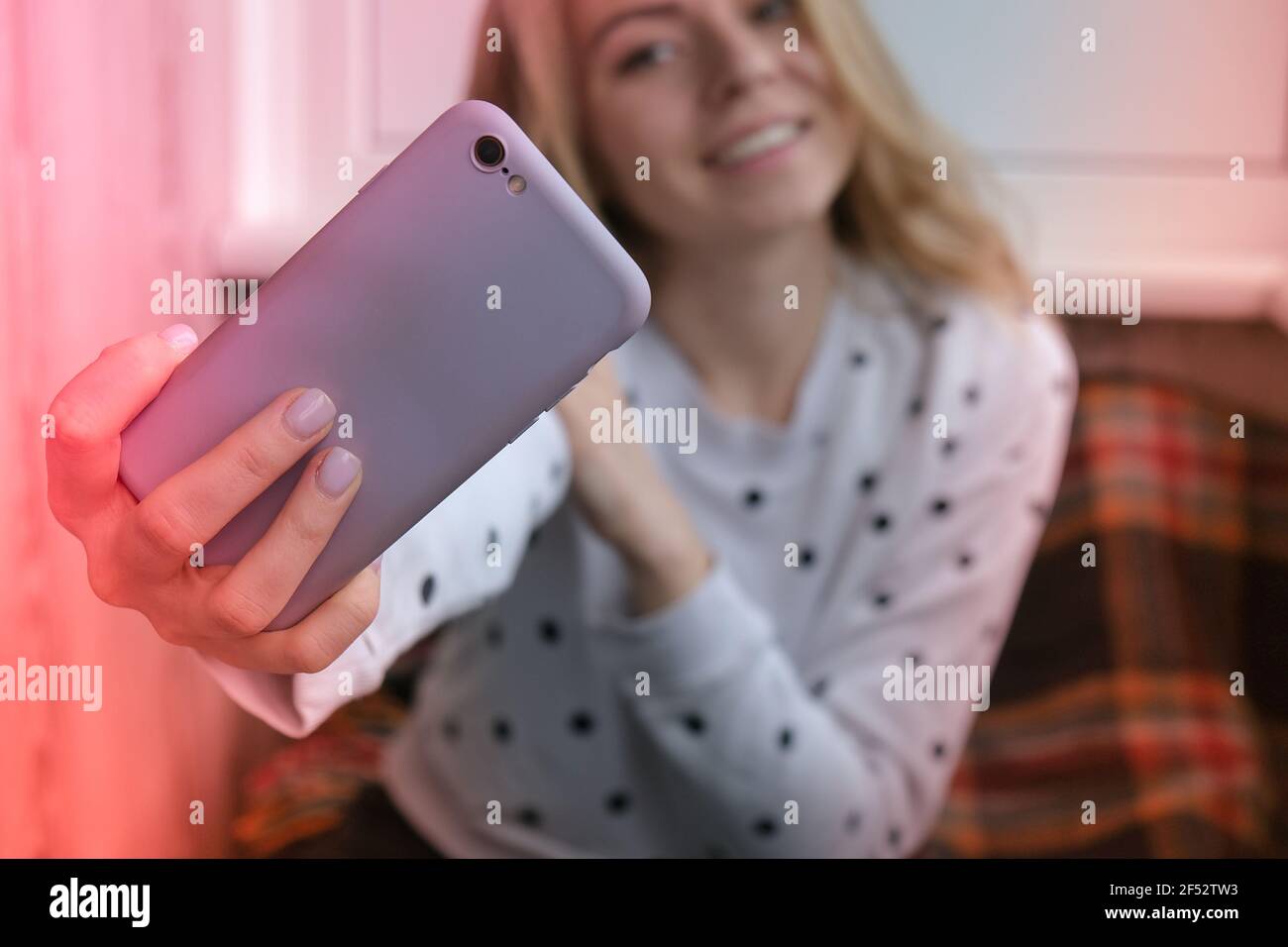 Blonde young girl taking selfie. Video call. Online education. Work ...