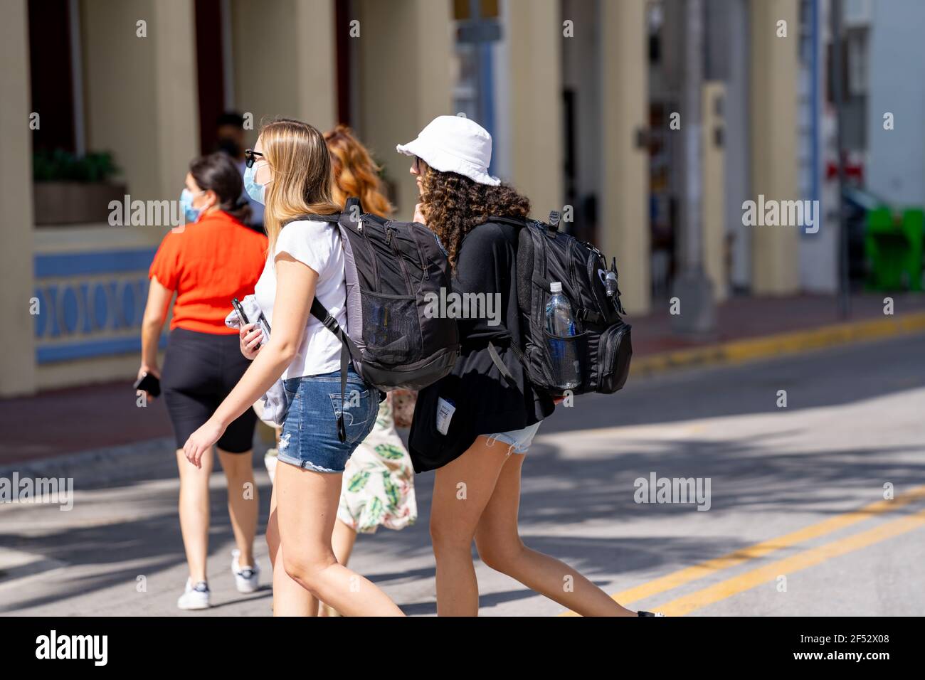 Women walking with backpacks in Miami Beach Spring Break 2021 Stock ...