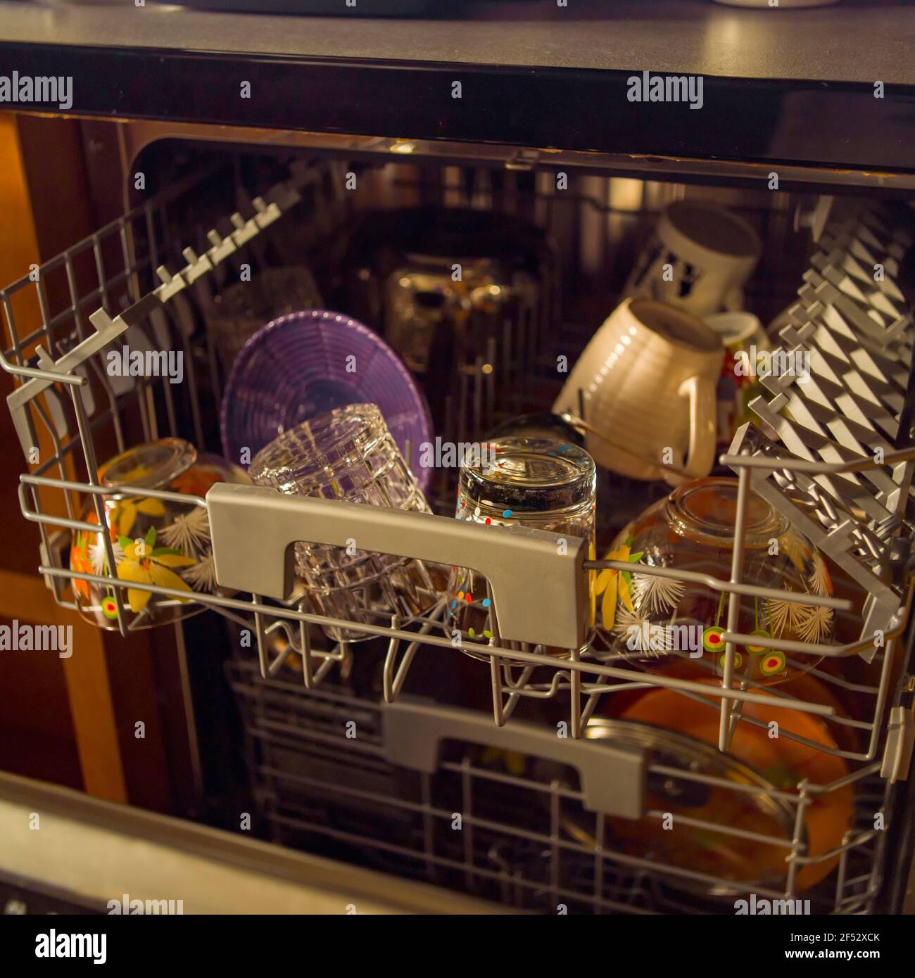 Closeup of a dishwasher full of clean spotless dishware, indoor closeup ...