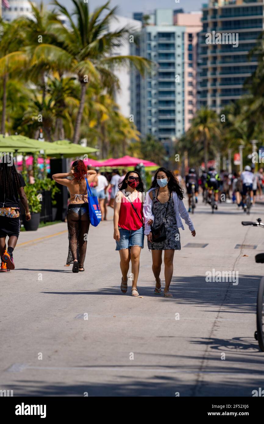 Woman walking and wearing face masks in Miami Beach Spring Break 2021 ...