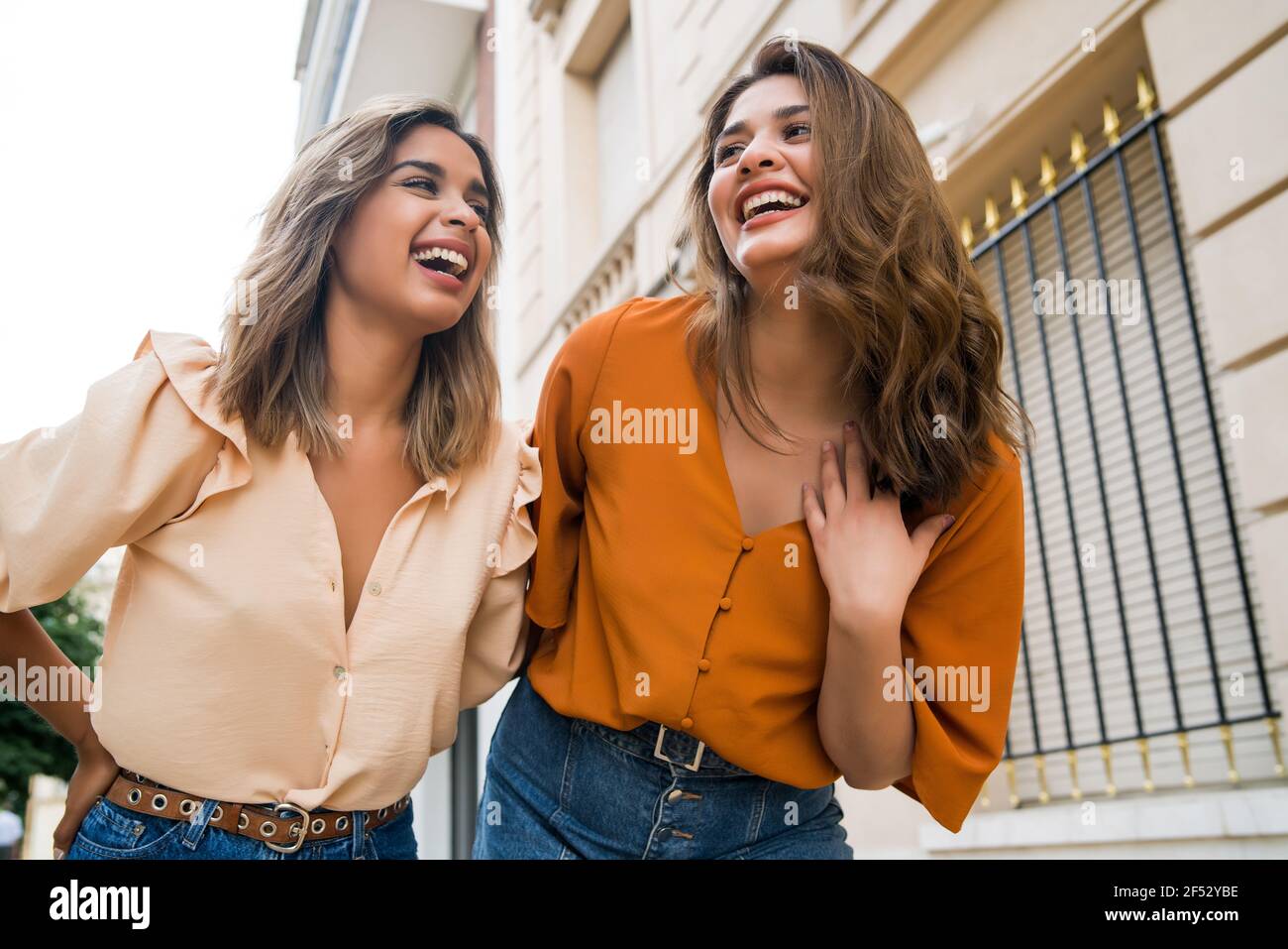 Two friends walking outdoors Stock Photo - Alamy