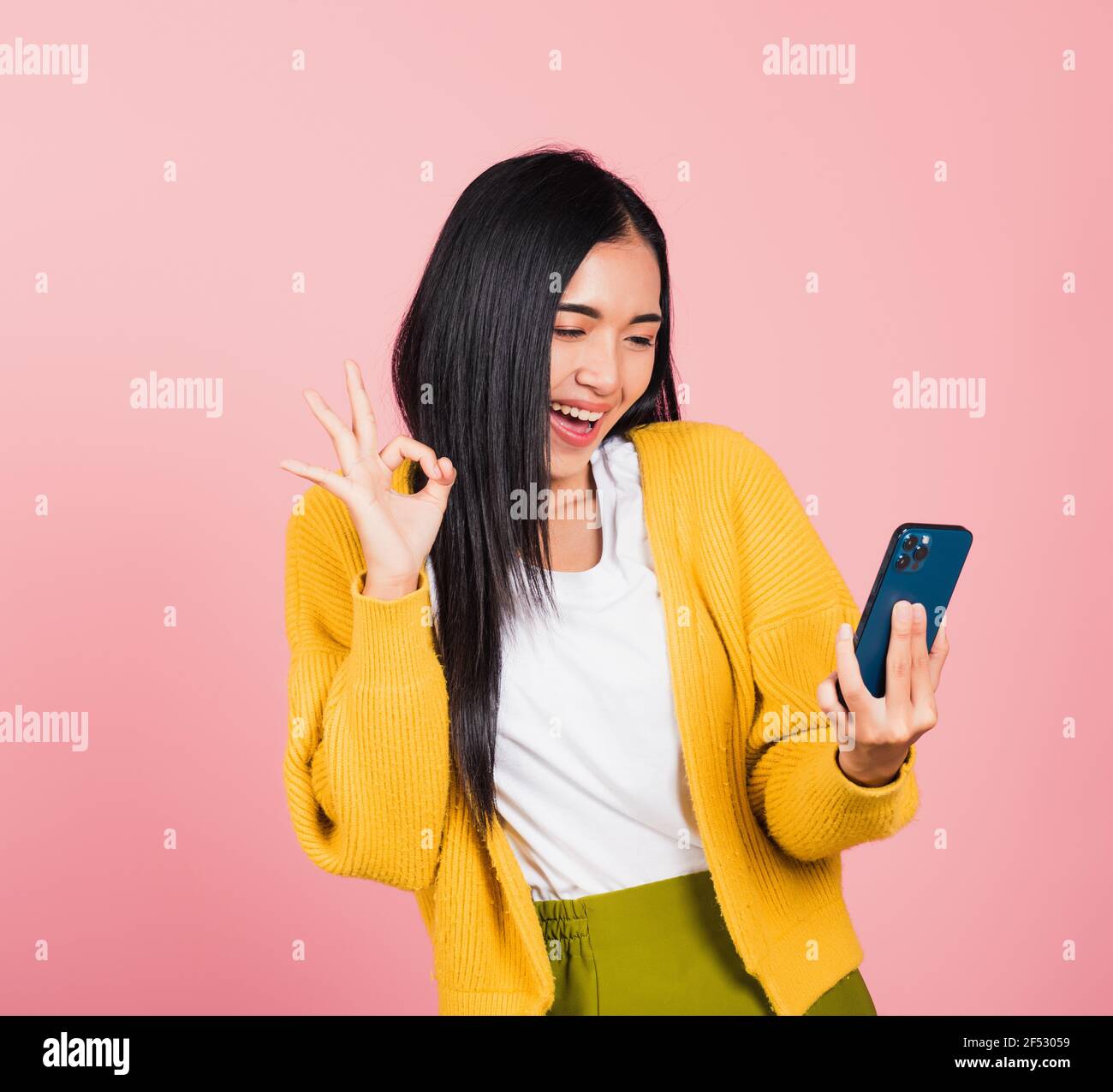 Happy Asian portrait beautiful cute young woman excited holding mobile ...
