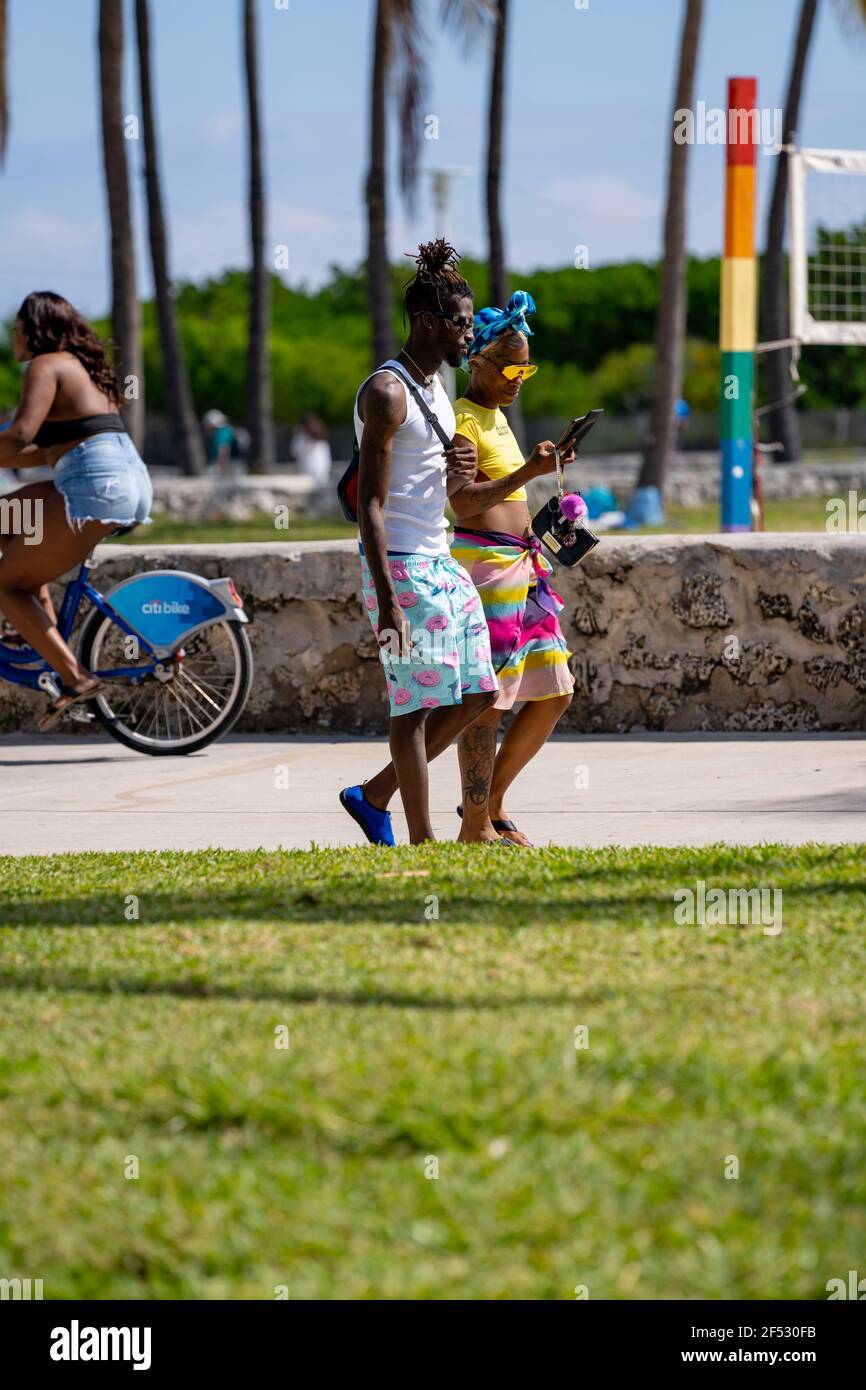 Flamboyant style couple walking on Ocean Drive Miami Beach Spring Break ...