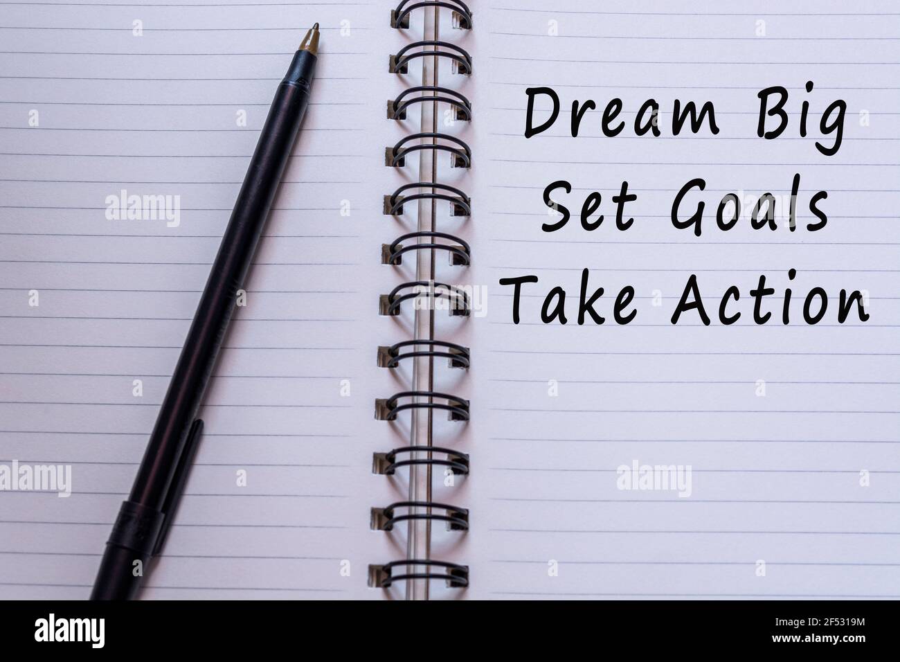 Motivational and inspirational quote on notepad with pen - Dream big ...
