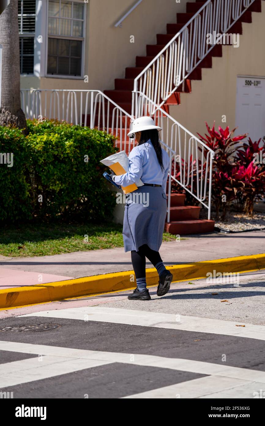 Mail carrier delivering mail to homes in Miami Beach FL USA Stock Photo ...