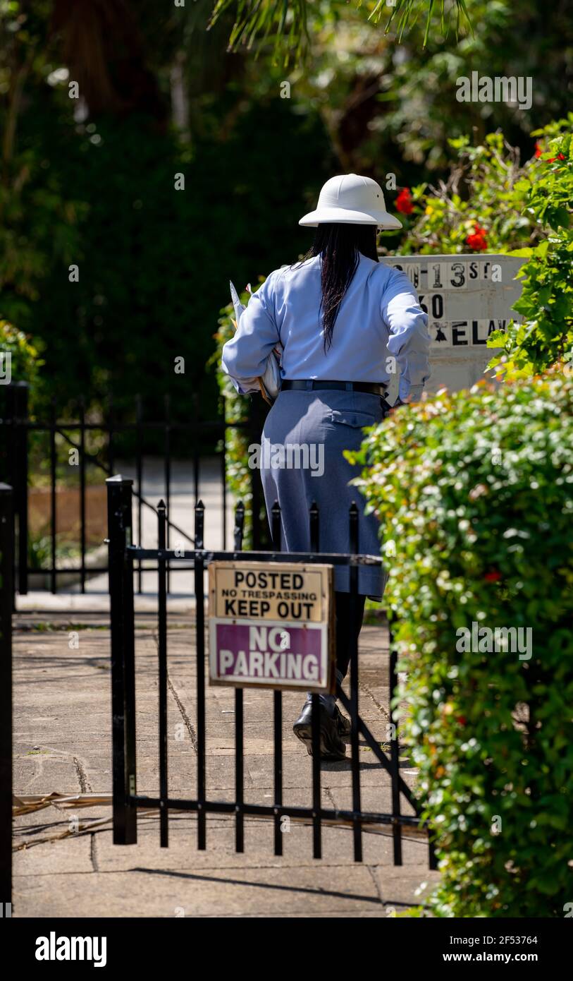 Mail woman delivering mail to boxes in an apartment building Stock ...
