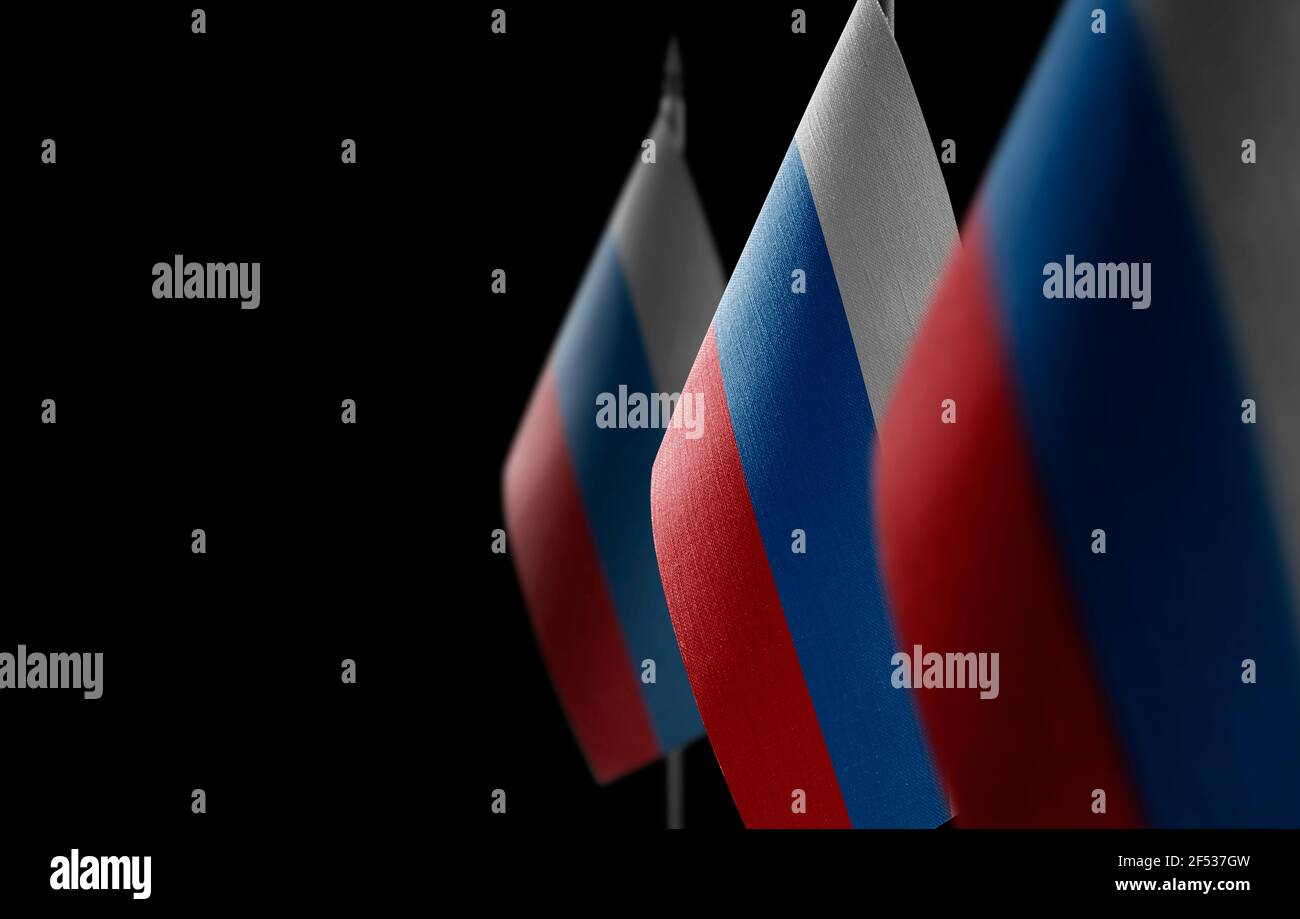 Small national flags of the Russia on a black background Stock Photo ...