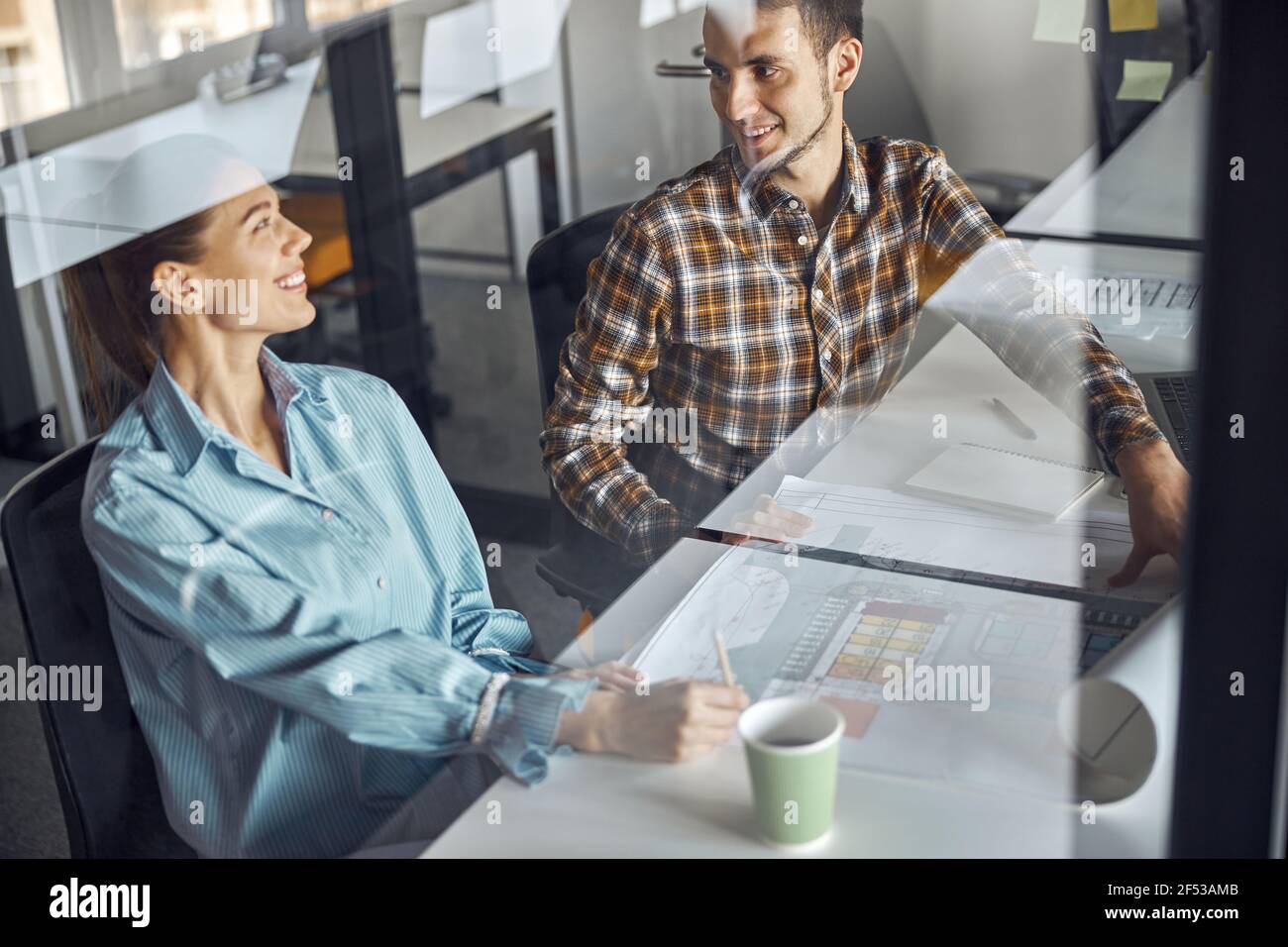 Smiling happy office employees sitting at the desk Stock Photo - Alamy
