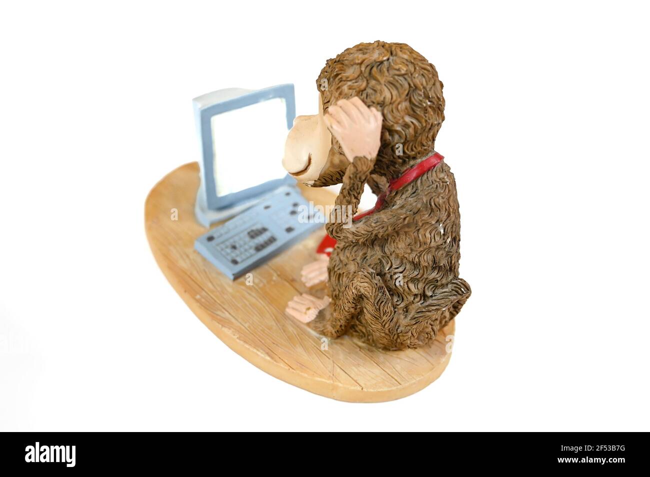 Monkey at the computer, statuette on an isolated background . High ...