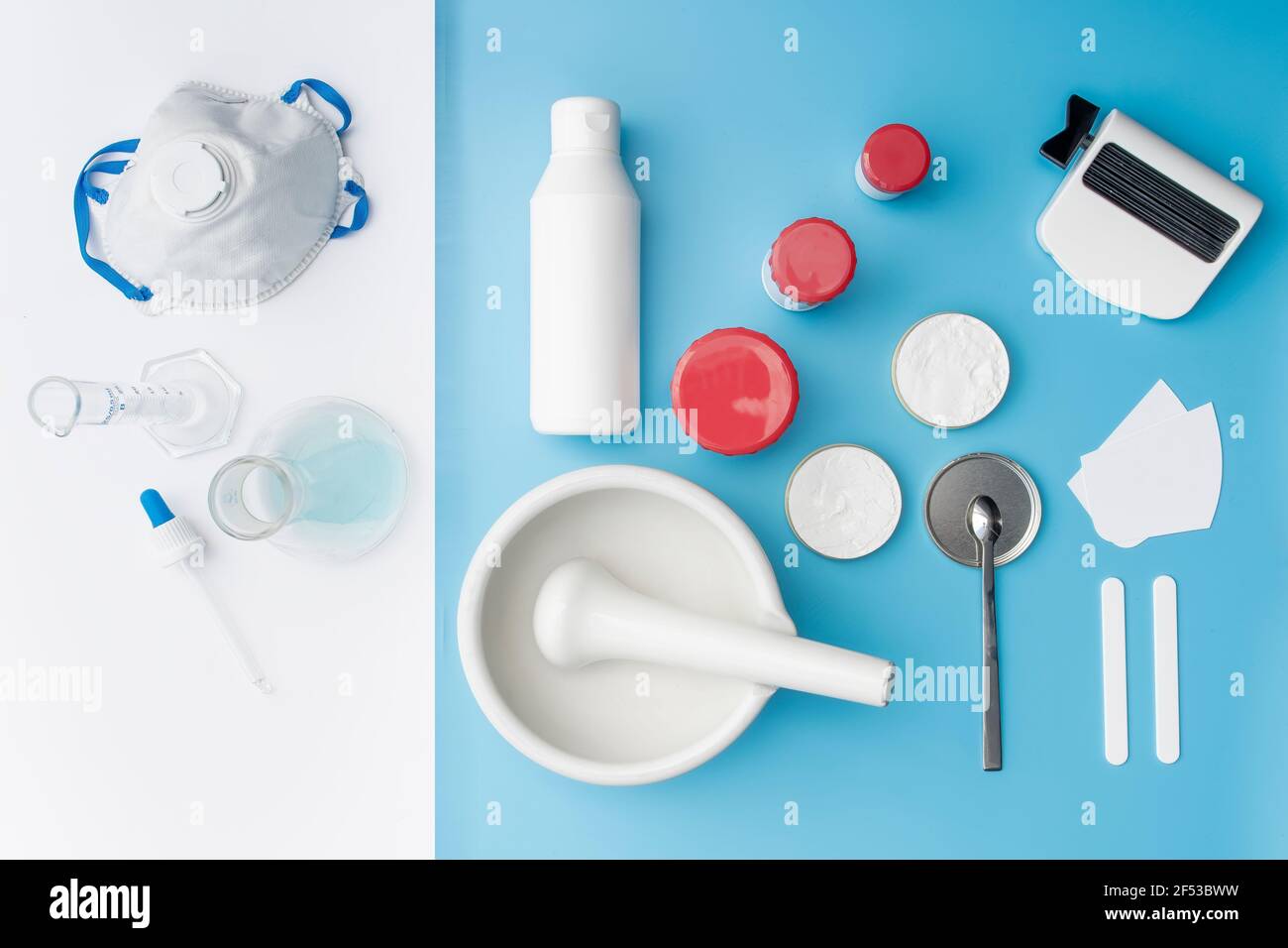 Pharmaceutical lab equipment ,flat or top view on white and blue table ...