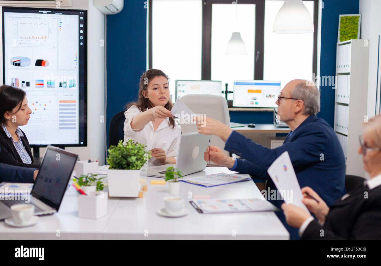 Team leader of start up giving tasks for multiethnic coworkers in ...