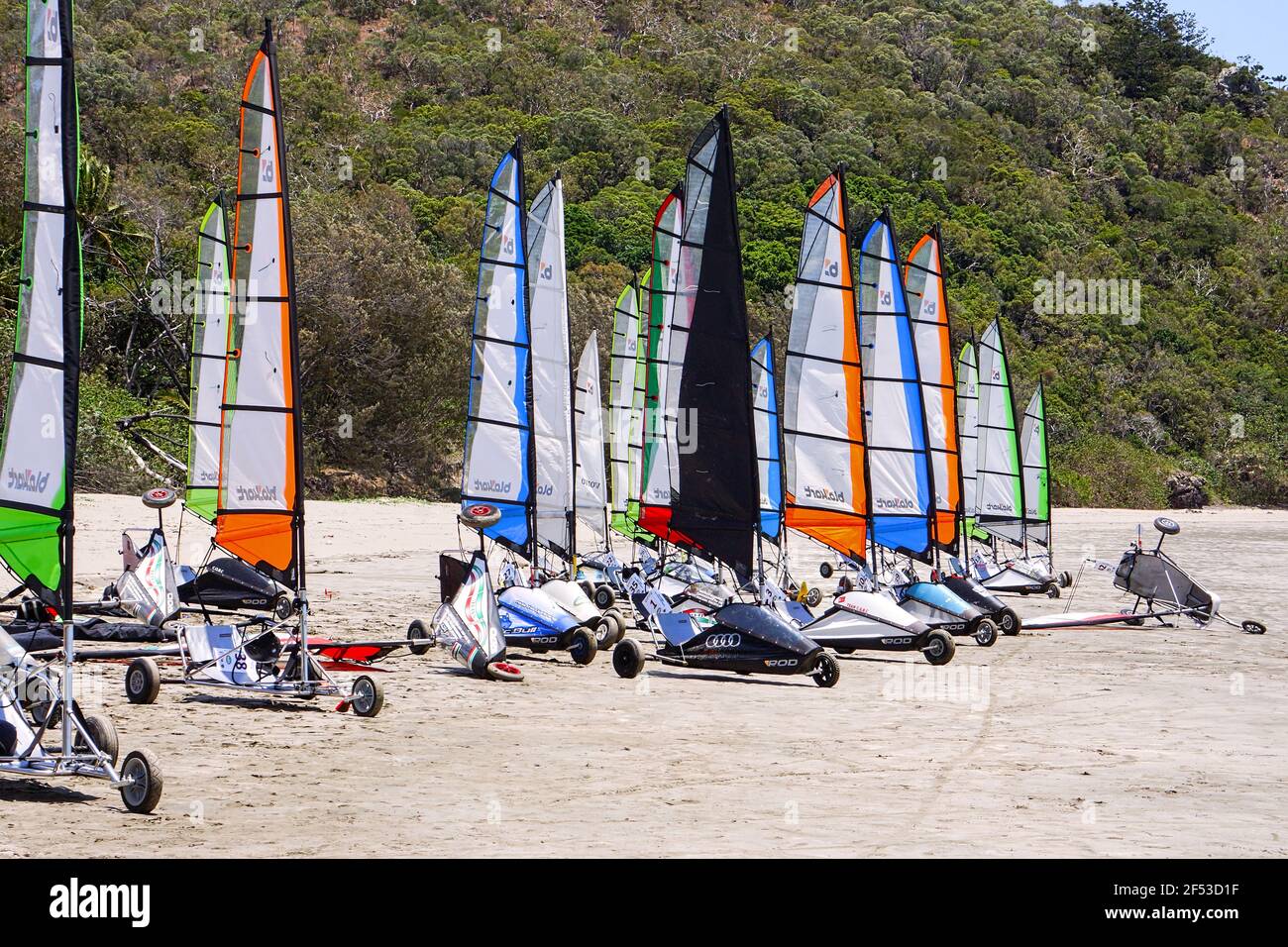 Colorful land sailing yachts parked line up on the beach in Queensland ...