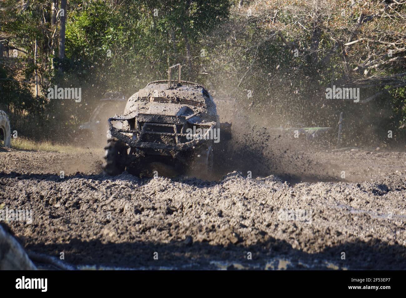 A crazy vehicle made from miscellaneous parts taking part in a mud race ...