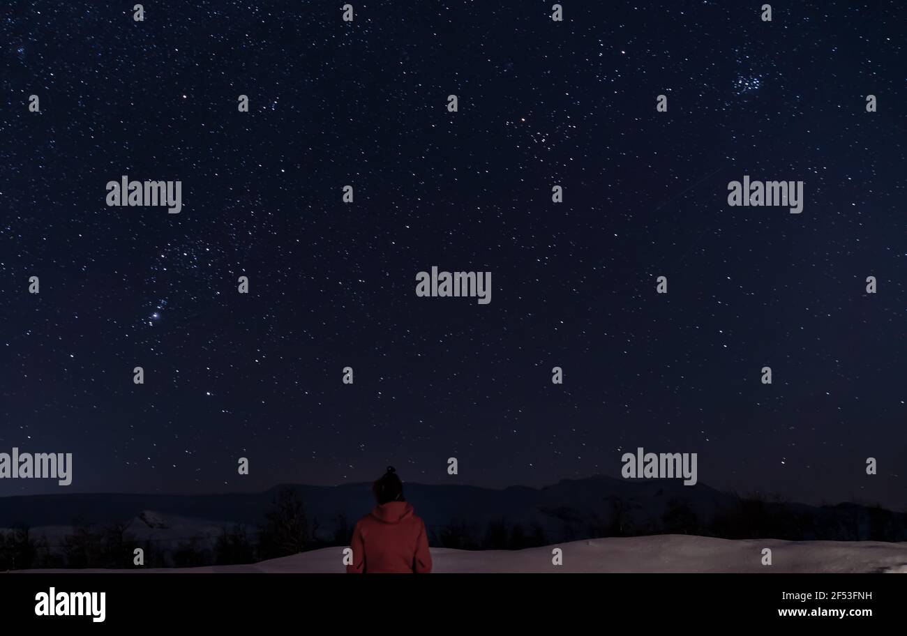 Person looking up at a clear and starry night sky on a cold clear ...