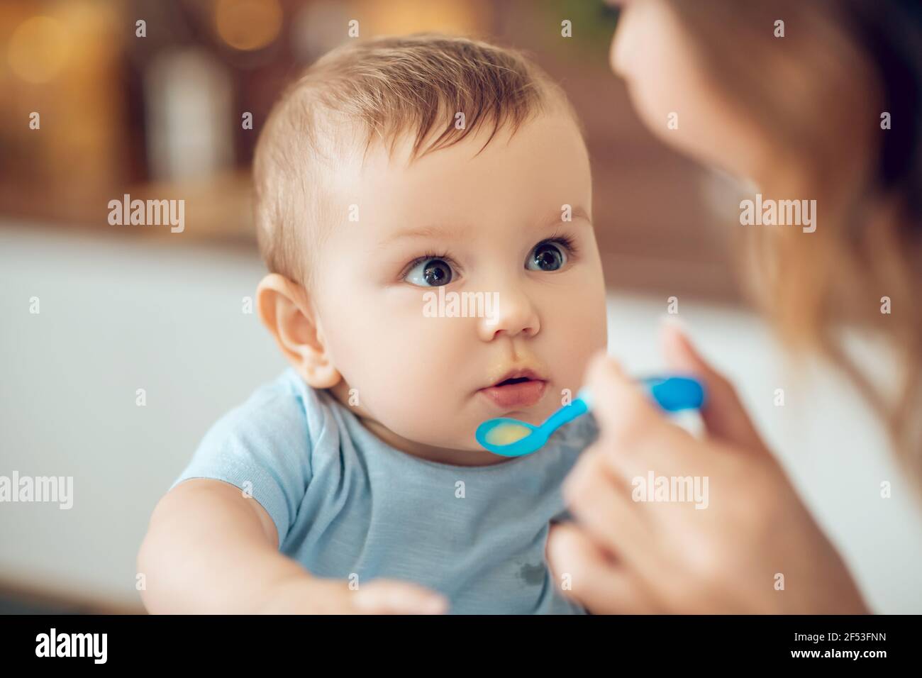 Cute little baby while taking food Stock Photo - Alamy