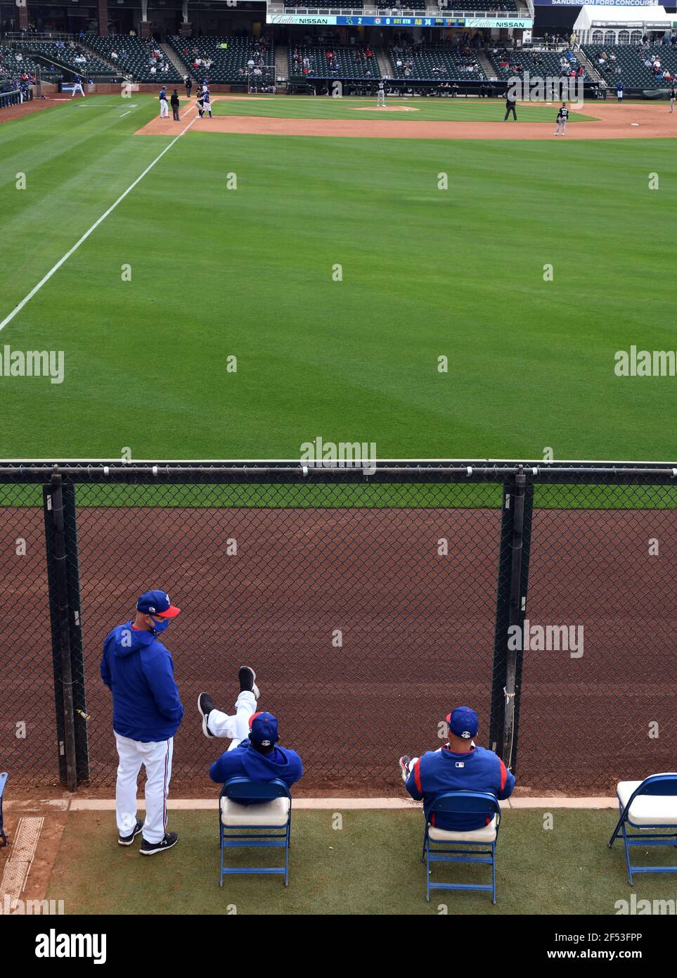 Players and coaches in the right field bullpen watch a MLB spring ...