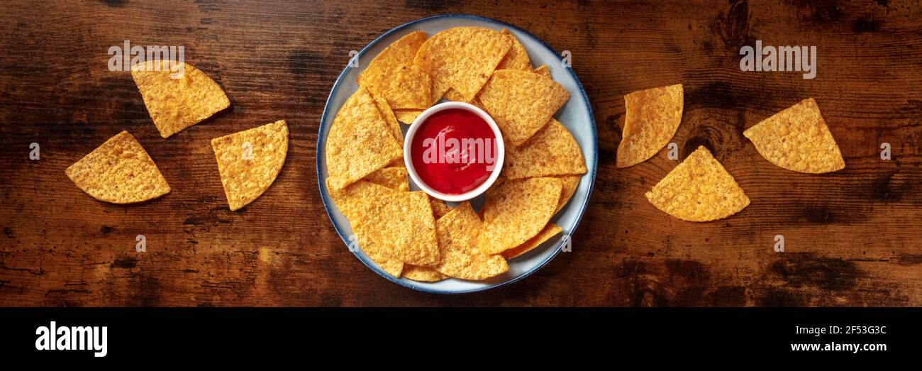 Nachos panorama with a tomato salsa, top shot Stock Photo - Alamy