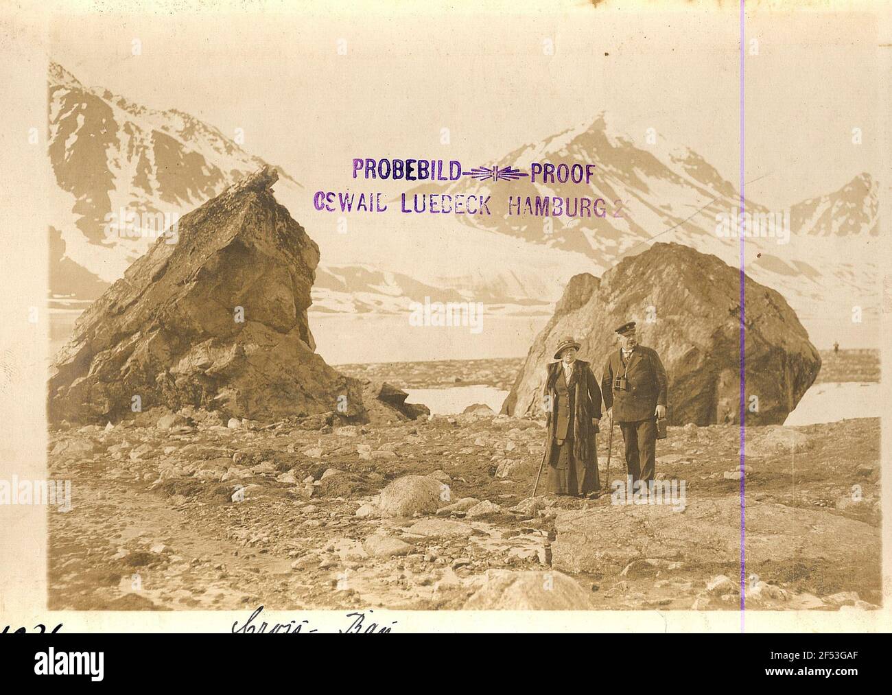 Spitzbergen (Norway). Married couple stands in front of two boulders on ...