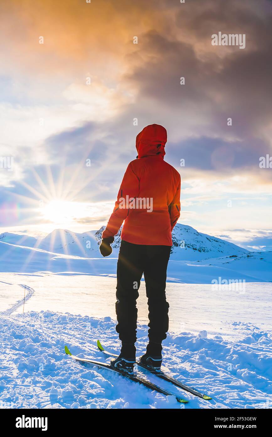 Female mountaineer and explorer enjoying a witner sunset Stock Photo ...