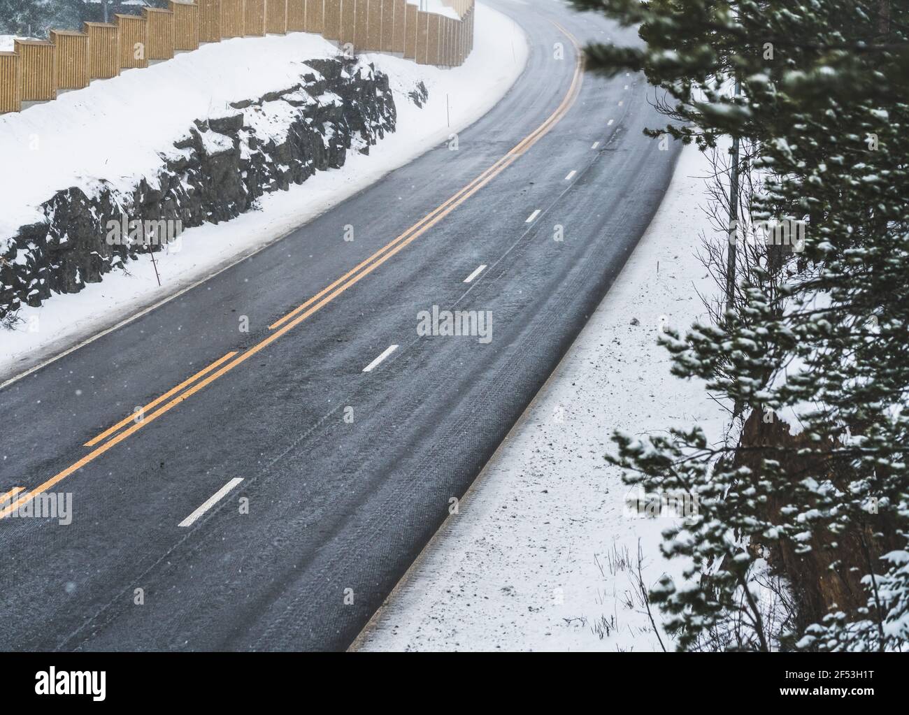 Highway with wet asphalt on a cold snowy winters day Stock Photo - Alamy