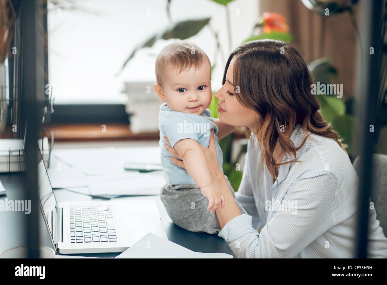 Profile of mom looking at her baby Stock Photo - Alamy