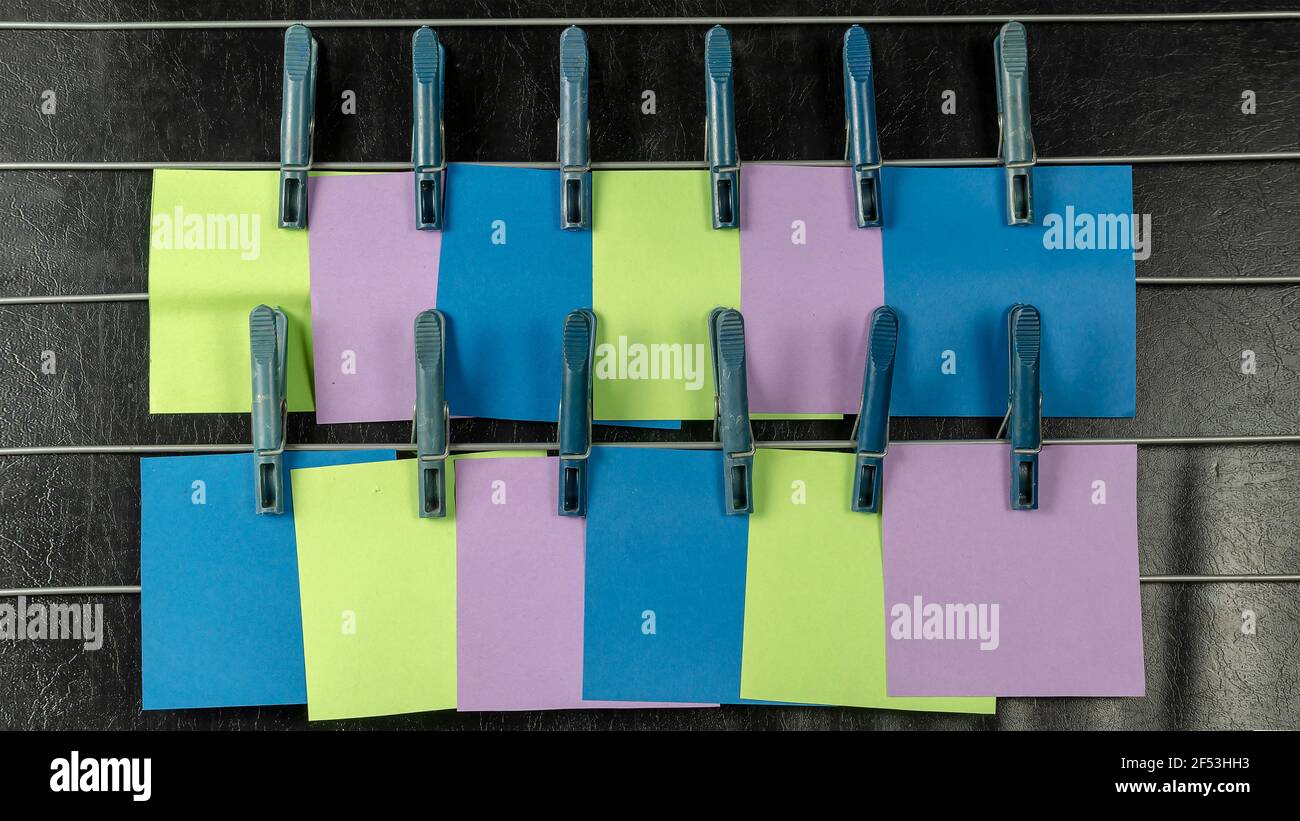 The paper sticky notes hanging from clothespins. Set of multicolored ...