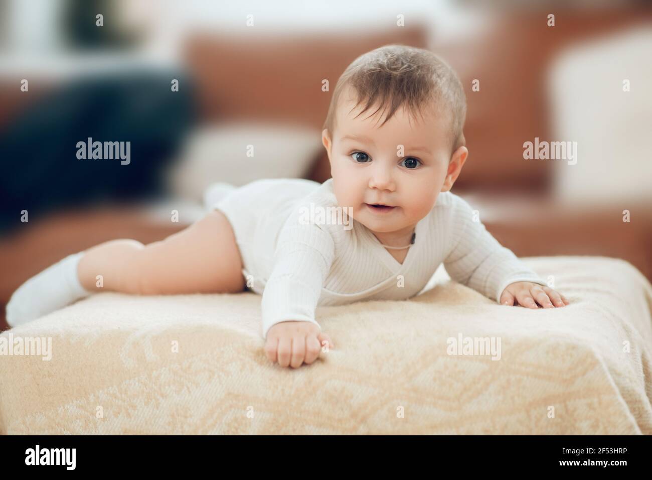 Small child lying on his stomach Stock Photo - Alamy