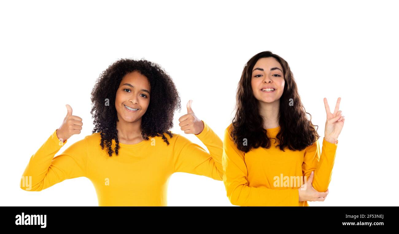Two cheerful women friends girls in yellow clothes isolated on a white ...
