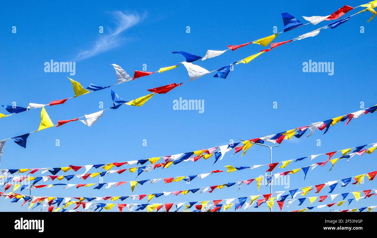 multi colored party rainbow flags on blue sky for celebration. Flags ...