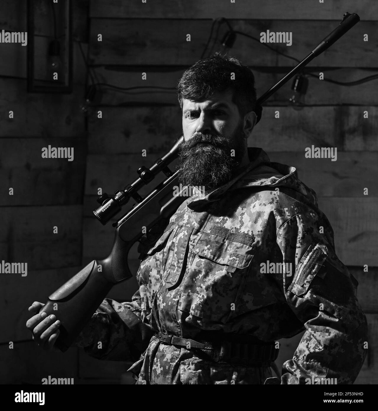 Hunter, brutal hipster on strict face with gun ready for hunting ...