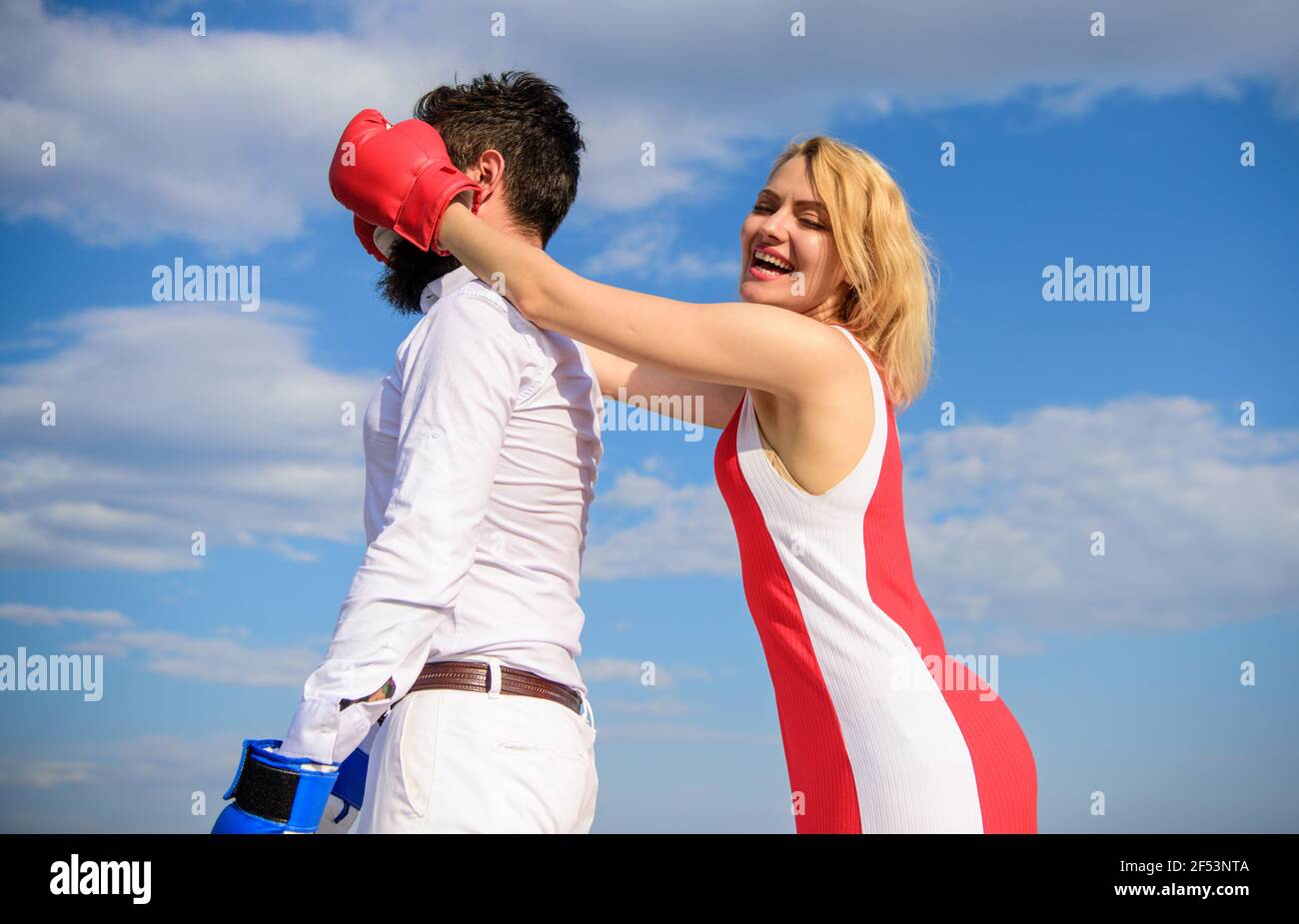 Couple in love boxing gloves blue sky background. Girl close his eyes ...
